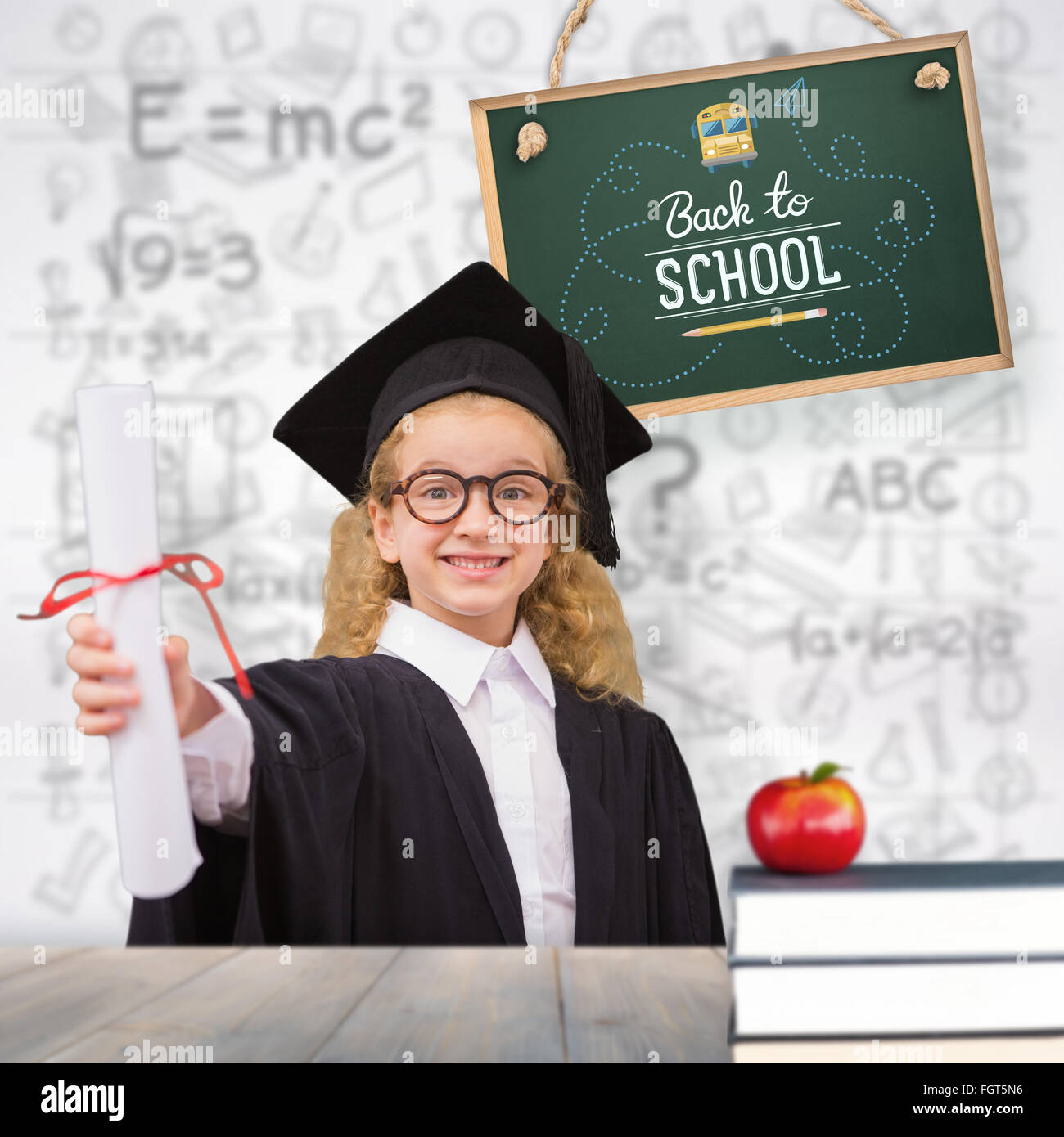 Composite image of schoolgirl with graduation robe and holding her ...