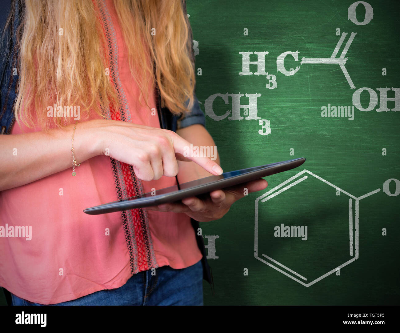 Composite image of student using tablet in library Stock Photo - Alamy