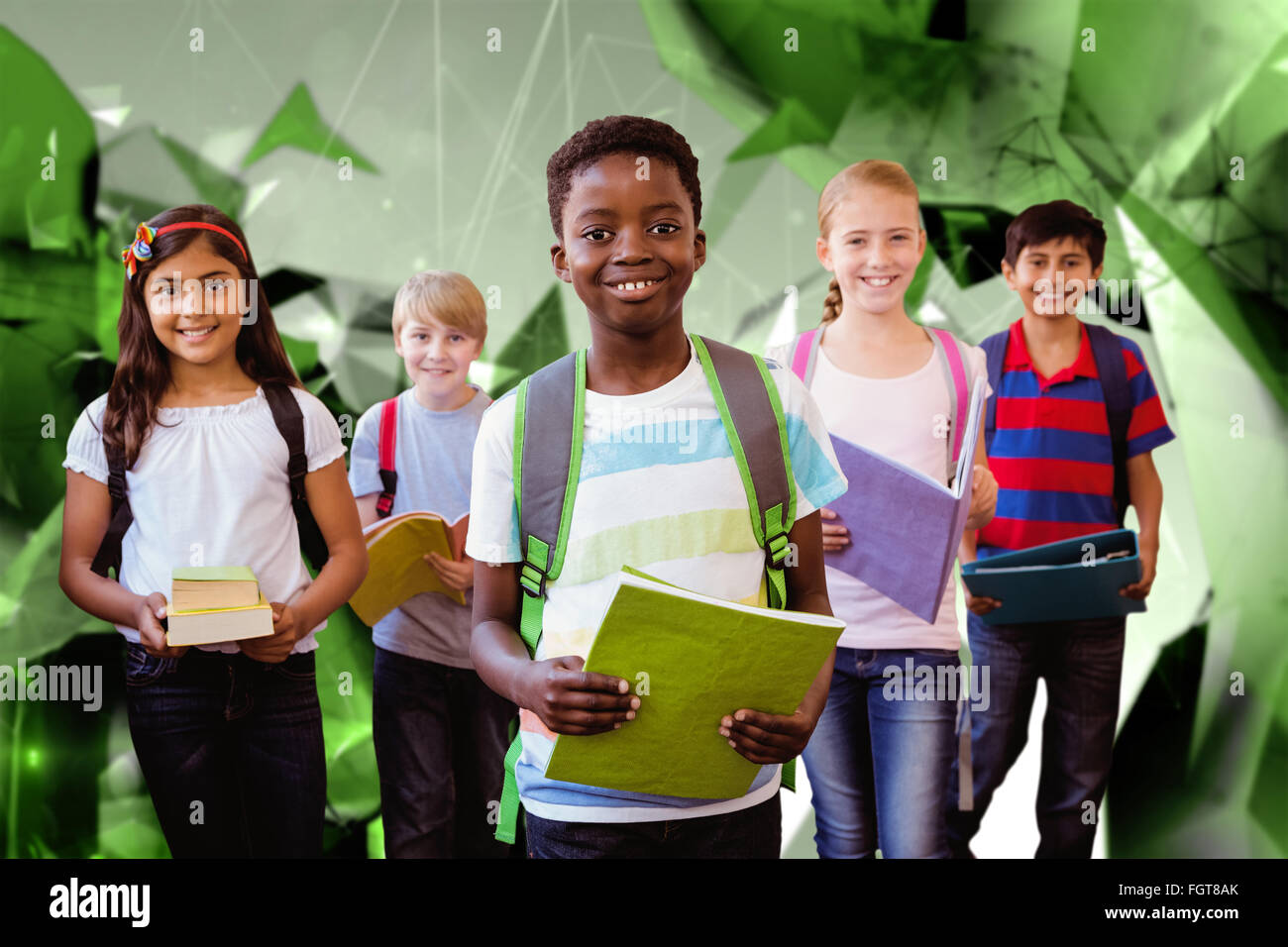 Composite image of smiling little school kids in school corridor Stock ...