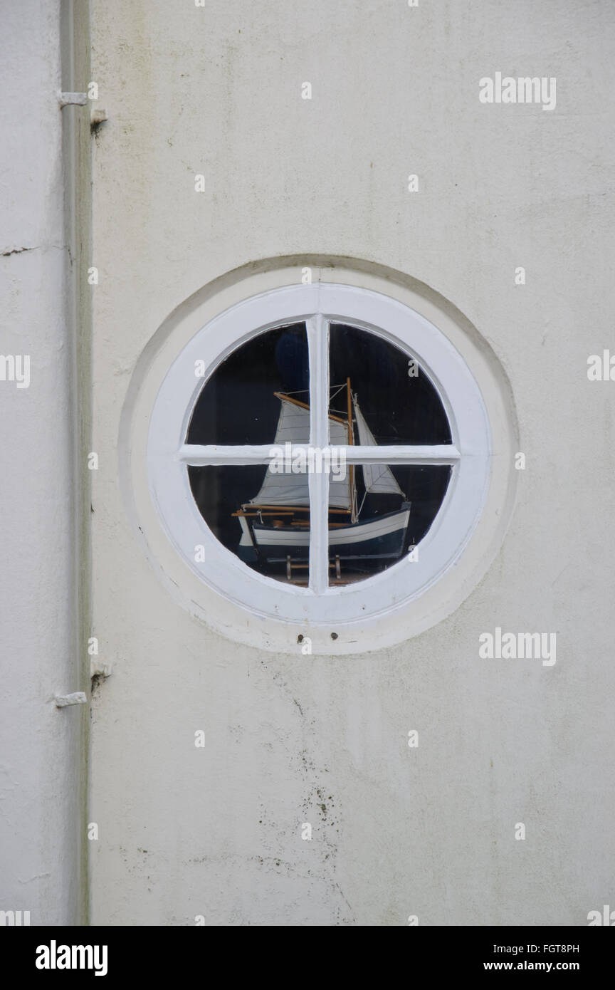 A model ship seen through a small round window Stock Photo - Alamy