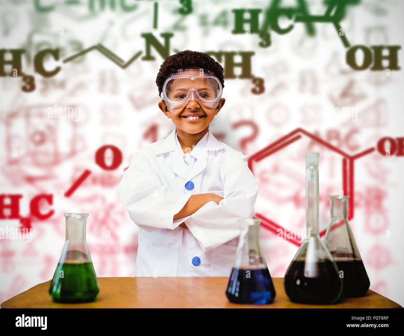Composite image of cute pupil dressed up as scientist Stock Photo - Alamy