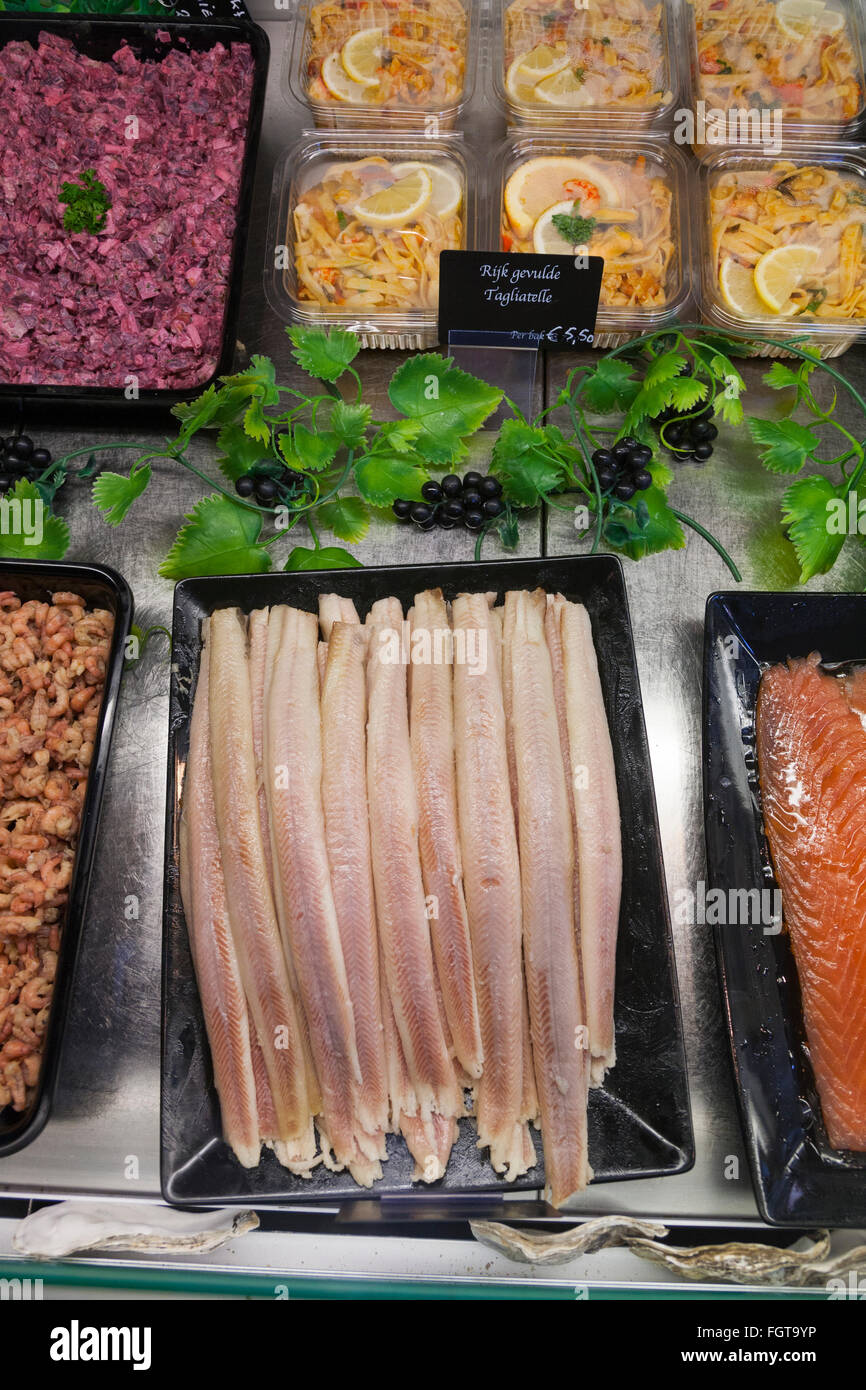 Fresh fish filling on display in chiller cabinet, for sale in a fish ...