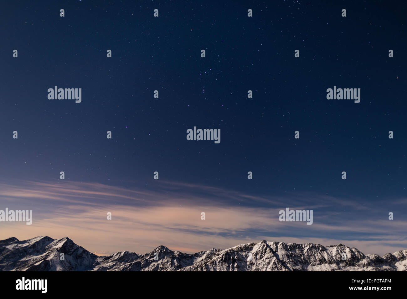 The starry sky captured on the Alps in winter. The Pleiades, Orion ...