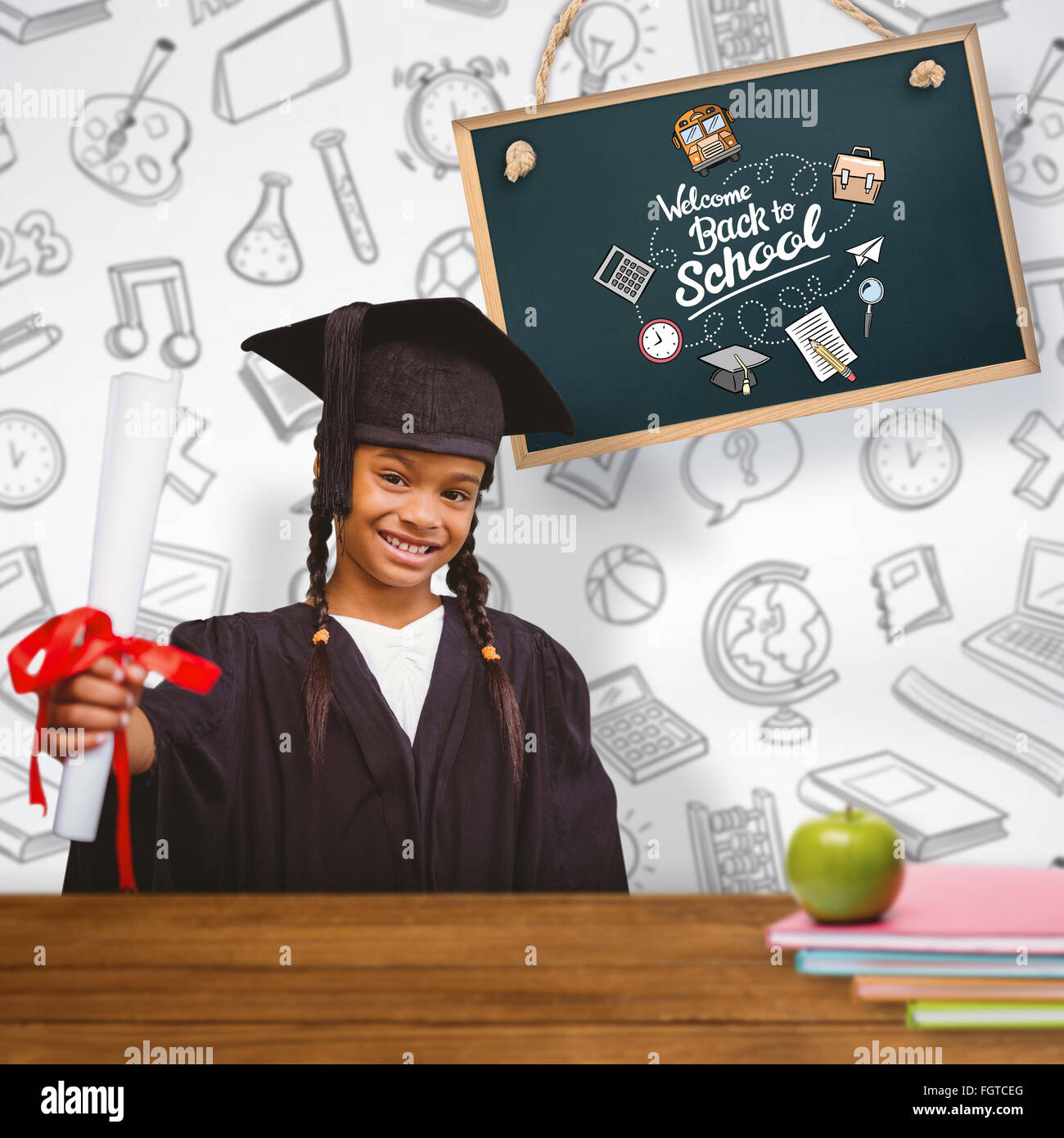 Composite image of cute pupil in graduation robe Stock Photo - Alamy