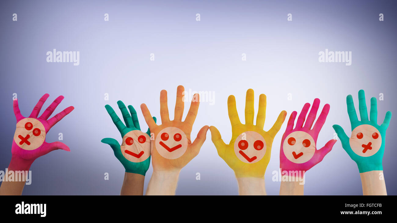Composite image of hands with colourful smiley faces Stock Photo - Alamy