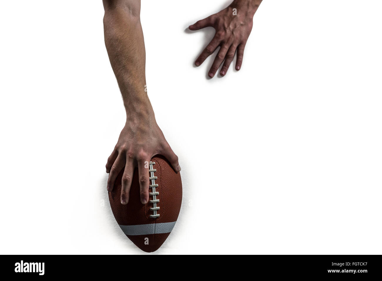 Cropped image of American football player holding ball Stock Photo - Alamy