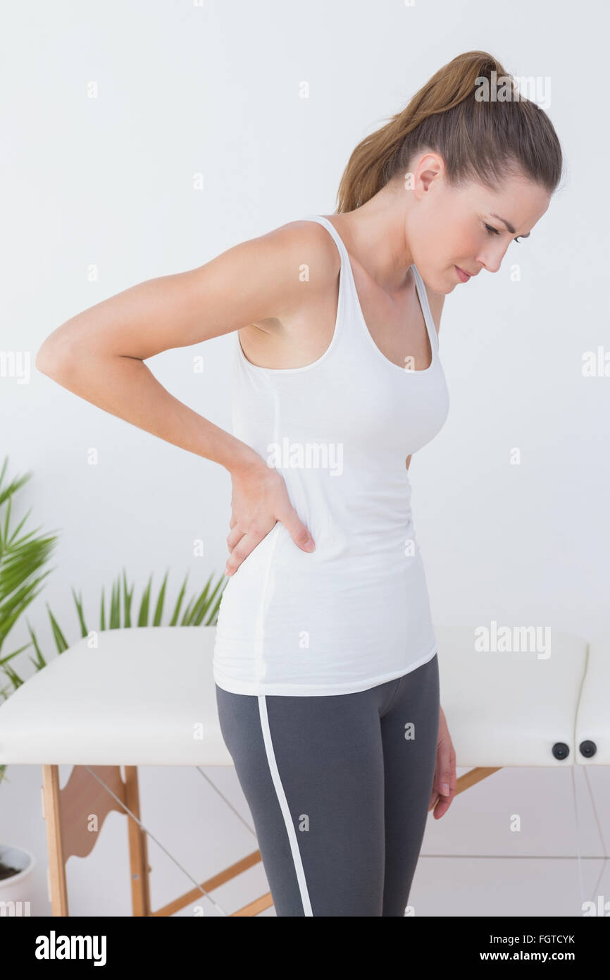 Suffering patient touching his back Stock Photo - Alamy