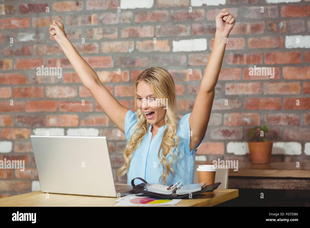 Happy businesswoman cheering in office Stock Photo - Alamy