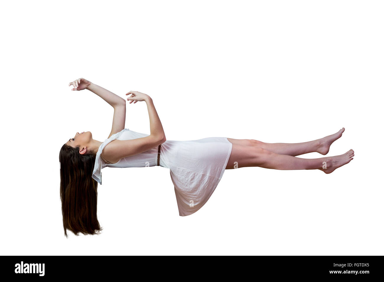 Girl in white dress floating in air Stock Photo - Alamy