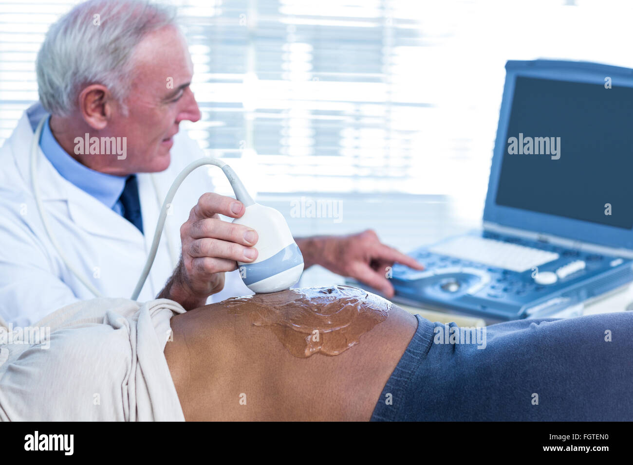 Happy doctor pointing towards screen Stock Photo - Alamy