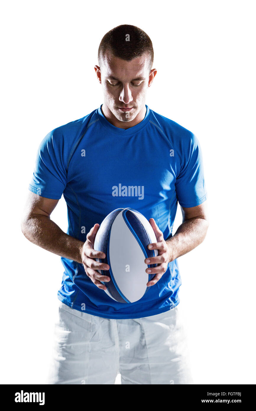 Rugby player holding ball Stock Photo - Alamy