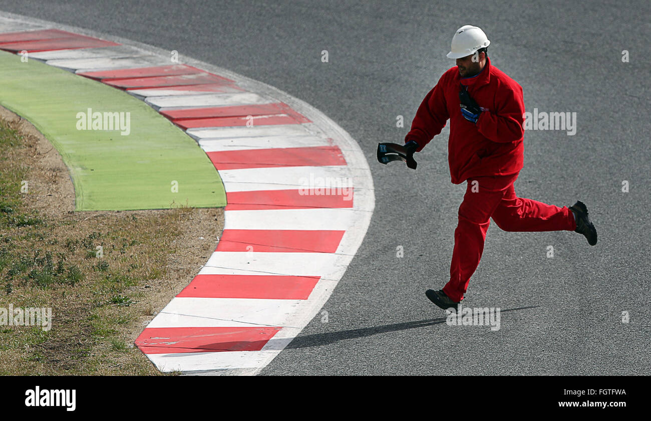 Barcelona, Spain. 22nd Feb, 2016. A race marshal runs across the track ...