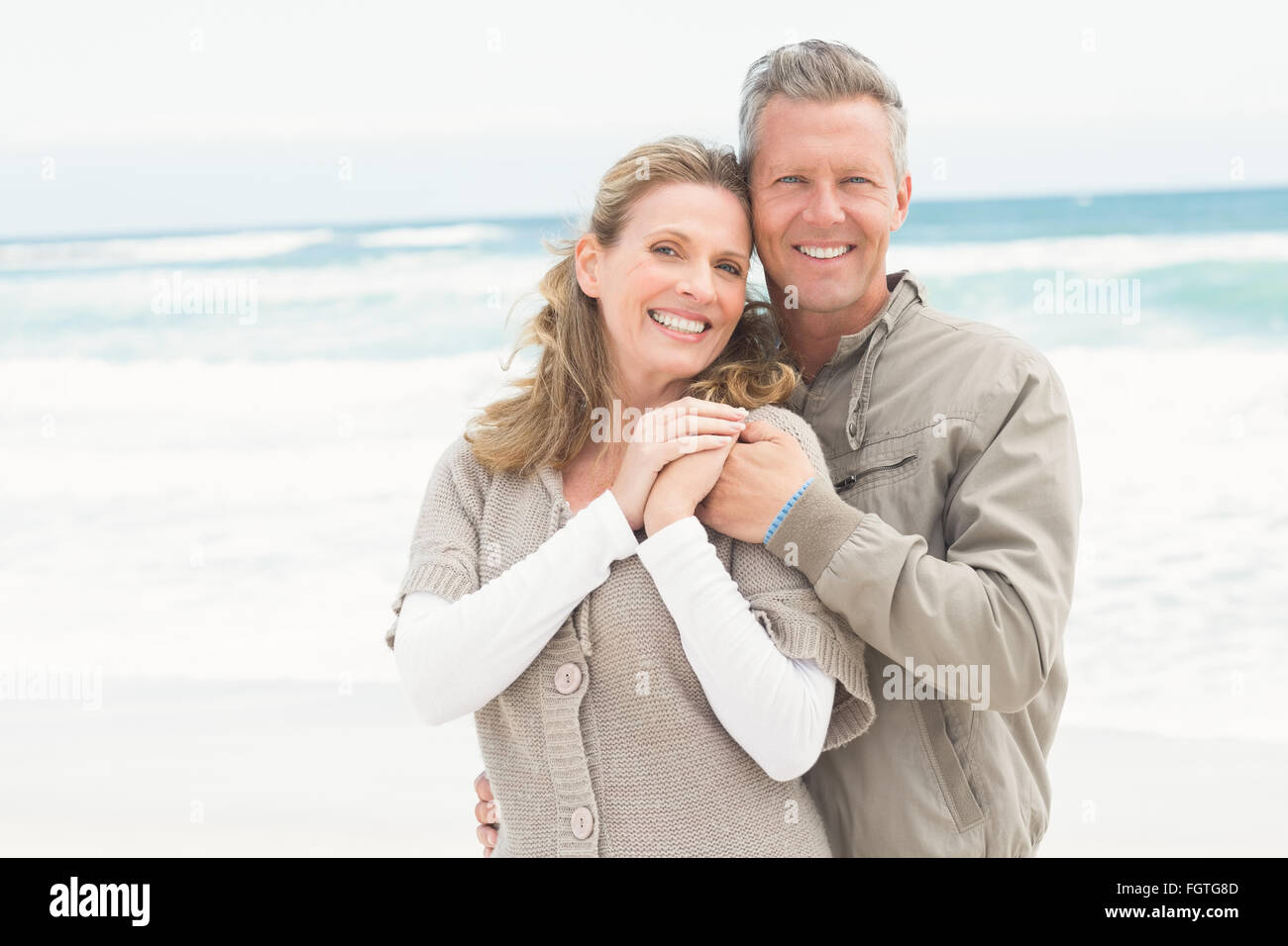 Smiling couple holding one another Stock Photo - Alamy