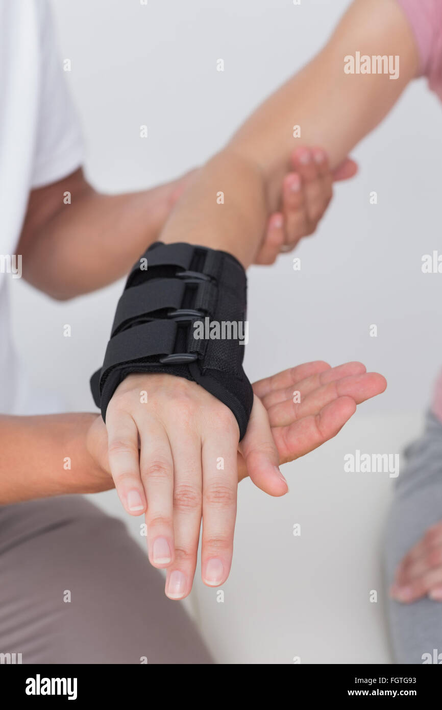 Doctor examining a woman wrist Stock Photo - Alamy