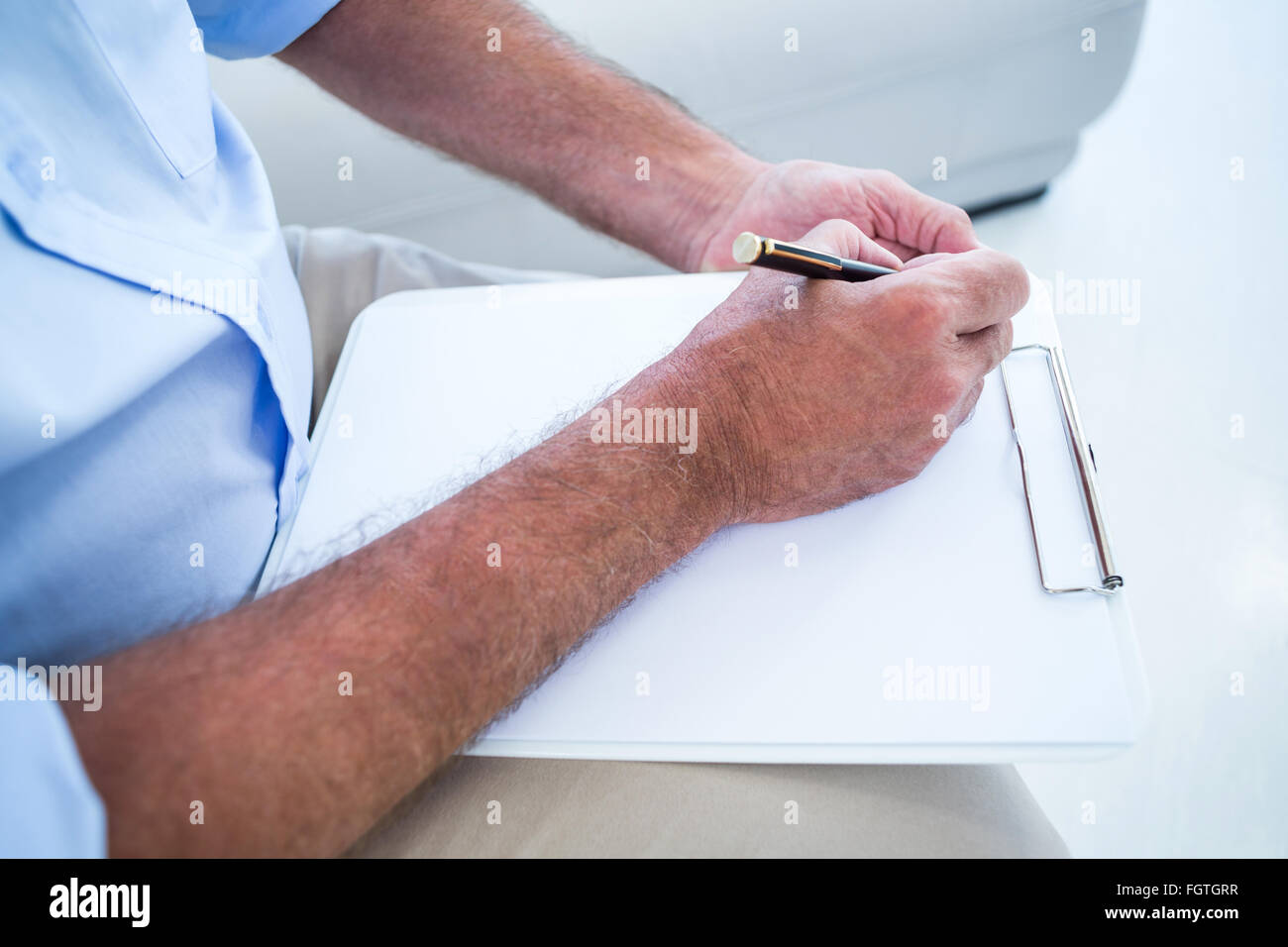 Man writing on notepad Stock Photo - Alamy