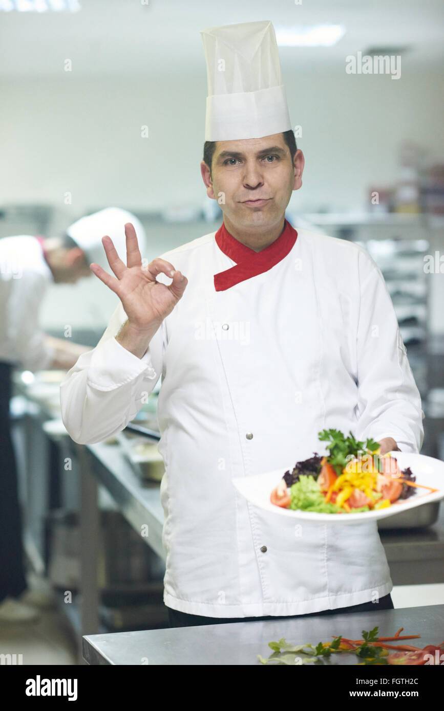 chef in hotel kitchen preparing and decorating food Stock Photo - Alamy