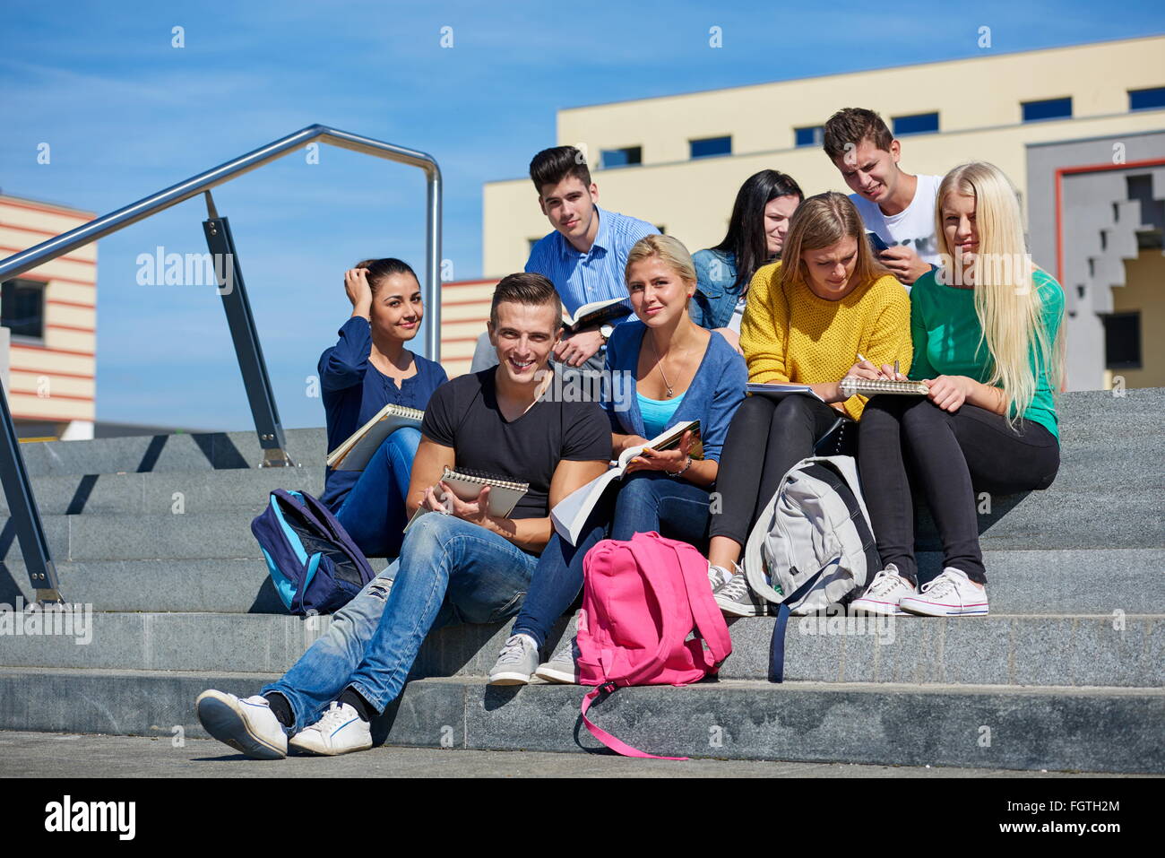 students outside sitting on steps Stock Photo - Alamy