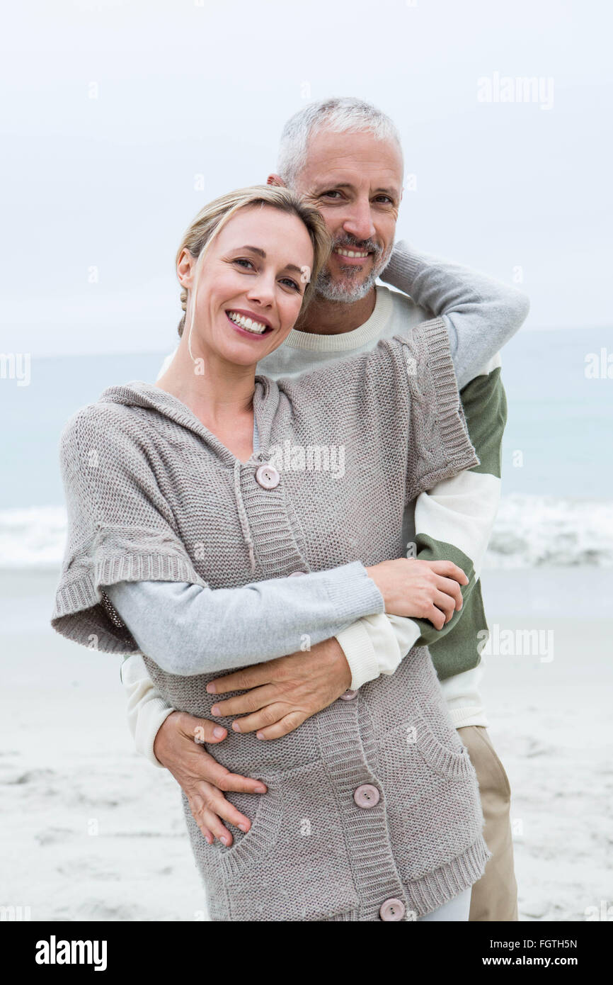 Smiling couple holding hands and hugging Stock Photo - Alamy