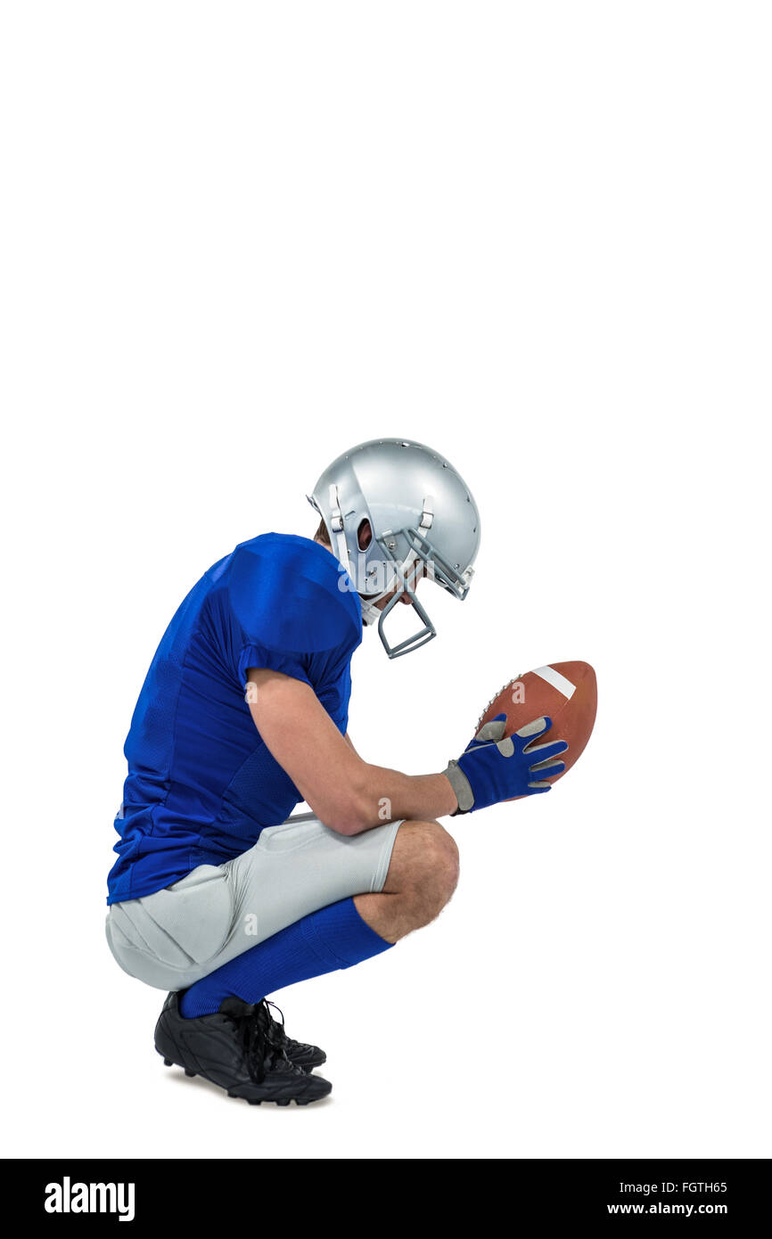 Profile view of American football player in attack stance Stock Photo ...