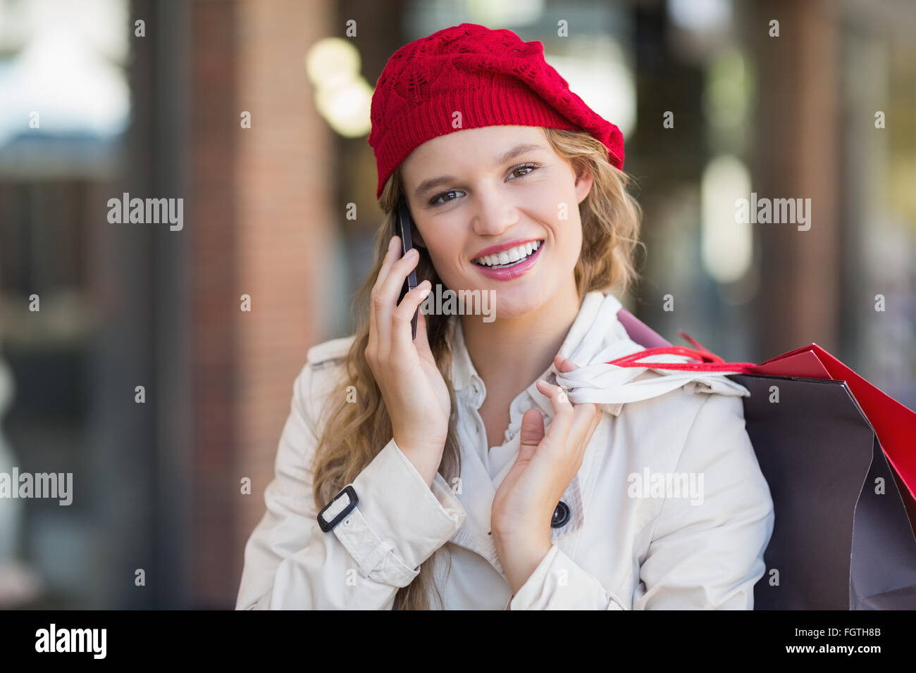 A smiling woman using her phone Stock Photo - Alamy