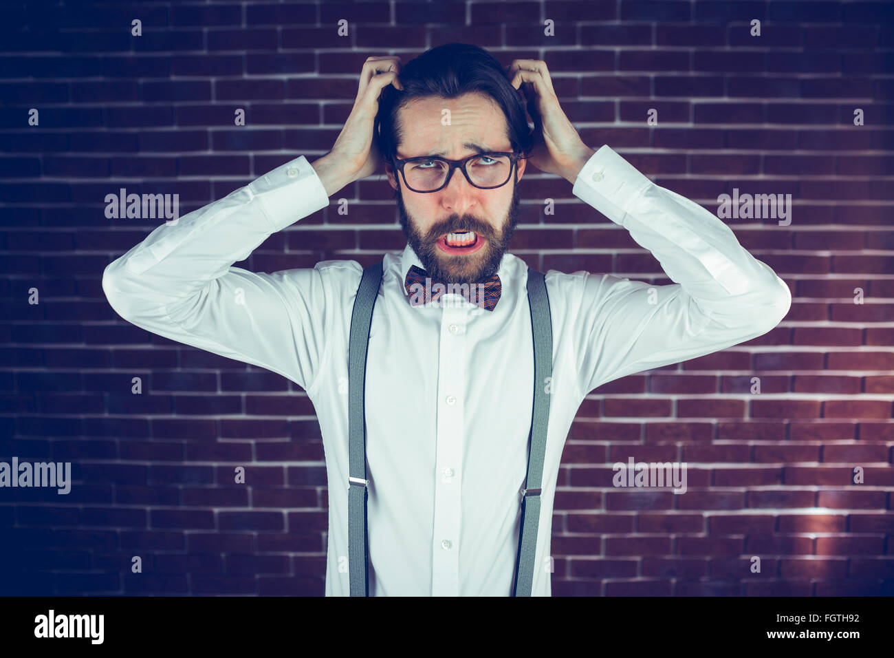 Portrait of angry man with head in hands Stock Photo - Alamy