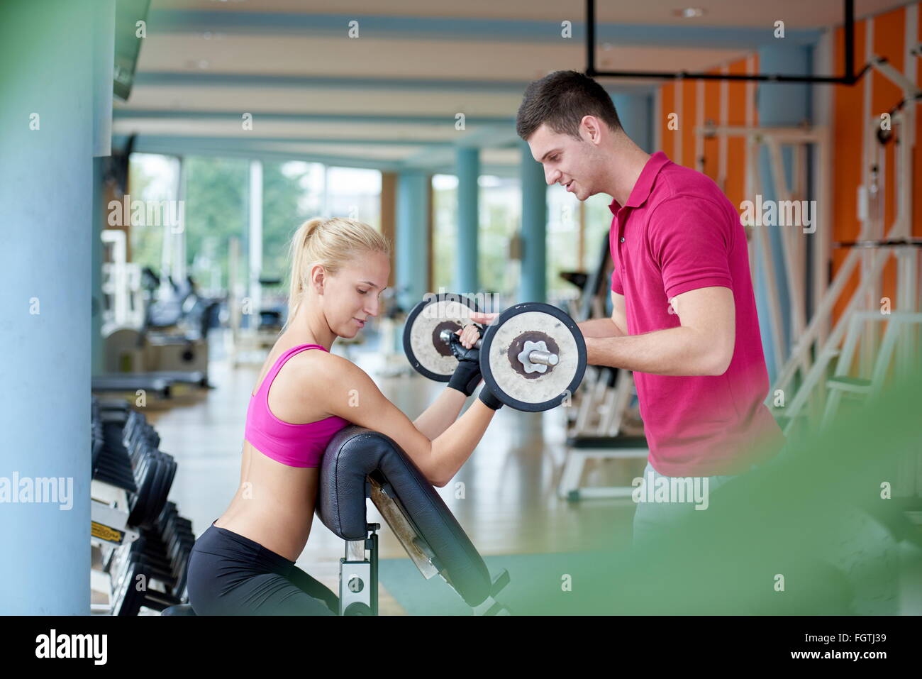 young sporty woman with trainer exercise weights lifting Stock Photo ...