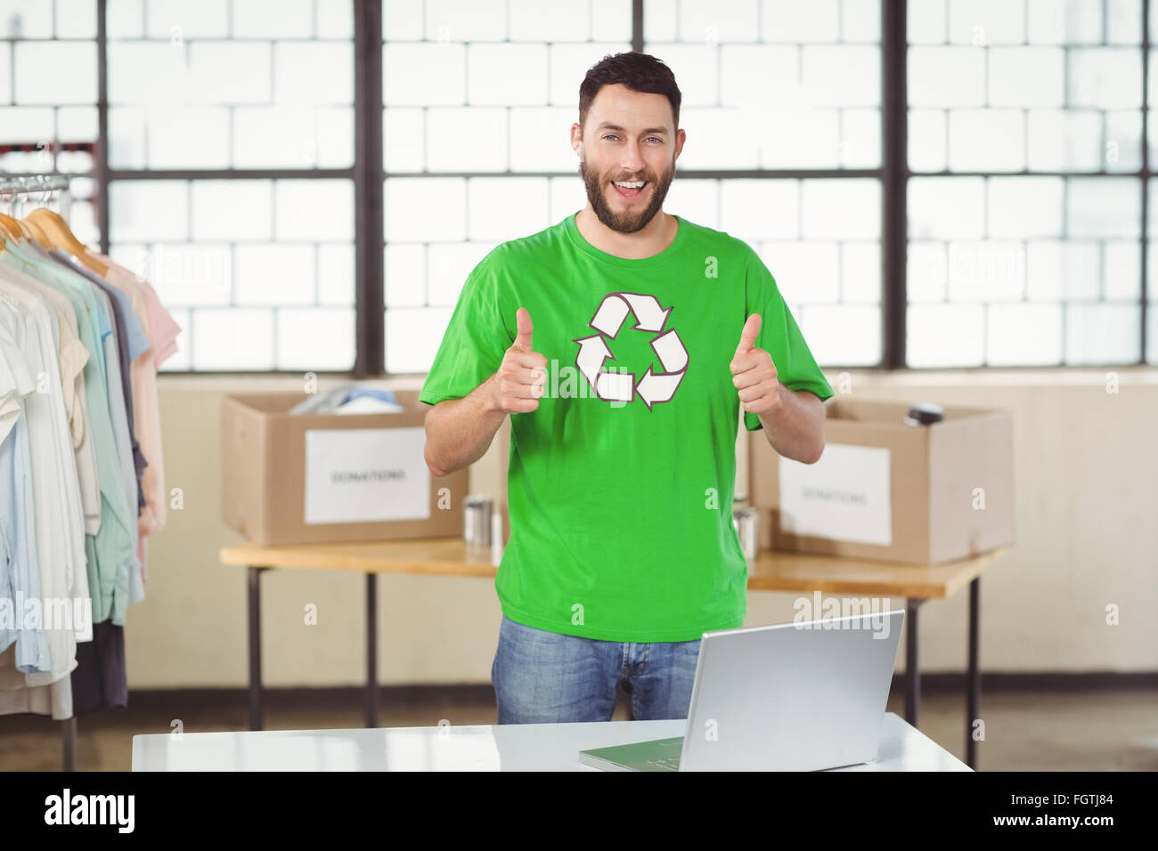Portrait of happy man in recycling symbol tshirt showing thumbs up ...