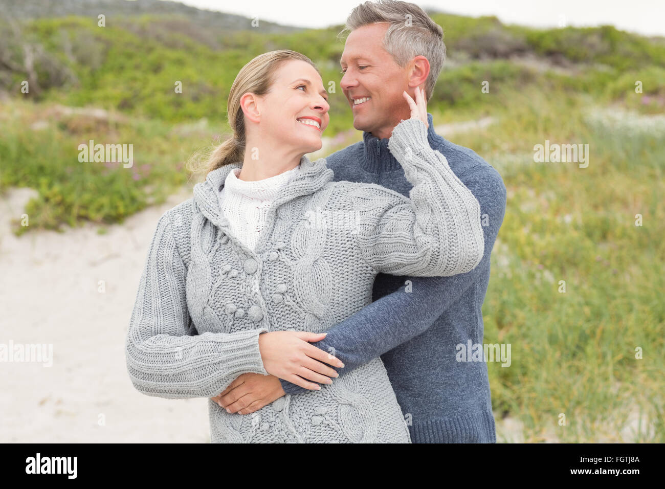 Smiling couple holding each other Stock Photo - Alamy