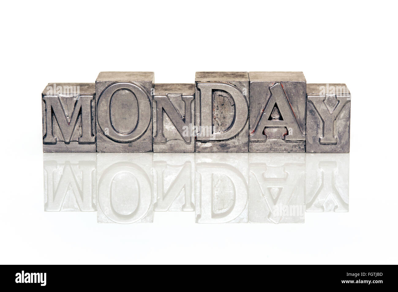 Monday word made from metallic letterpress type on reflective surface ...