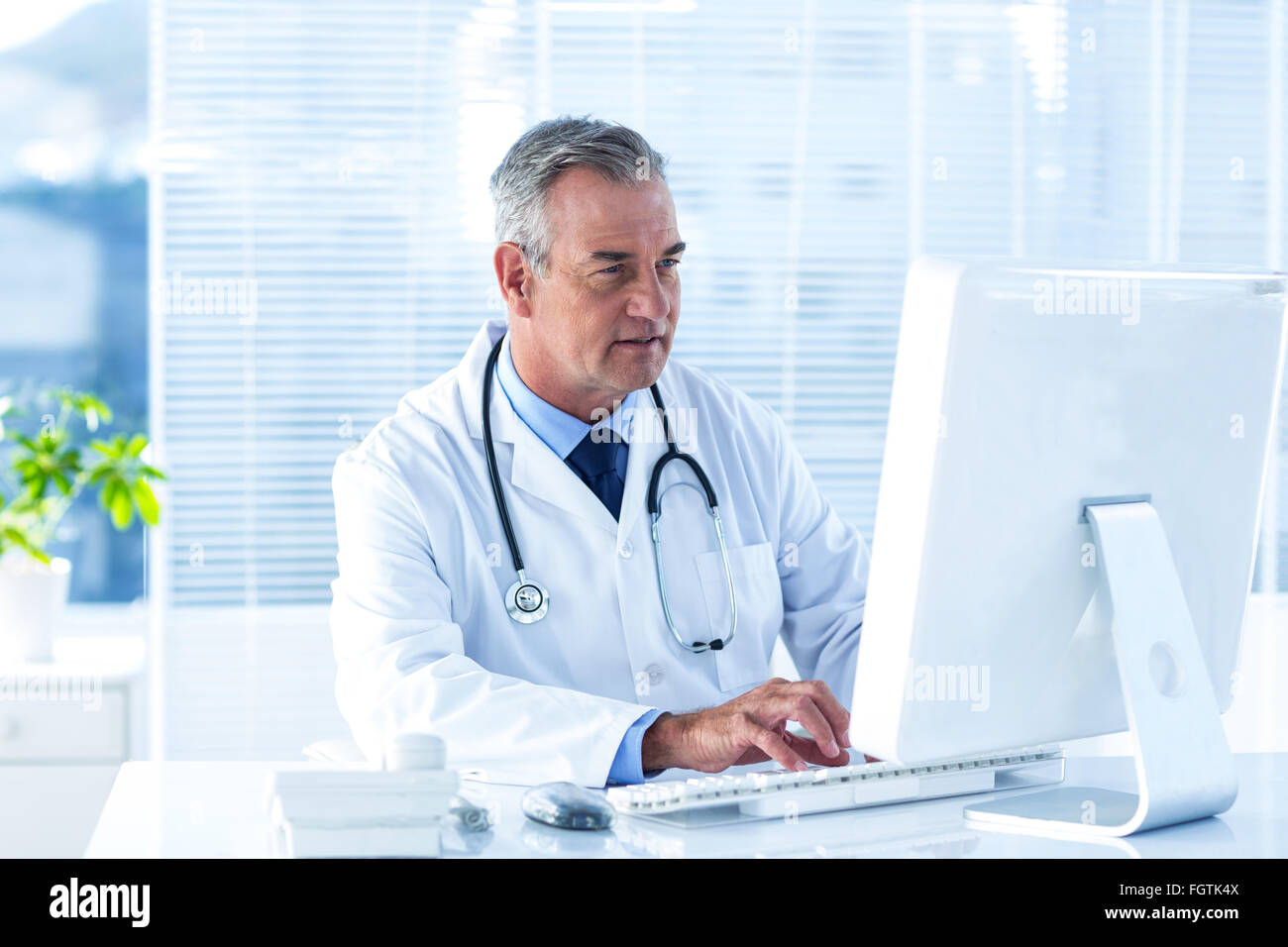 Male doctor using computer in hospital Stock Photo - Alamy