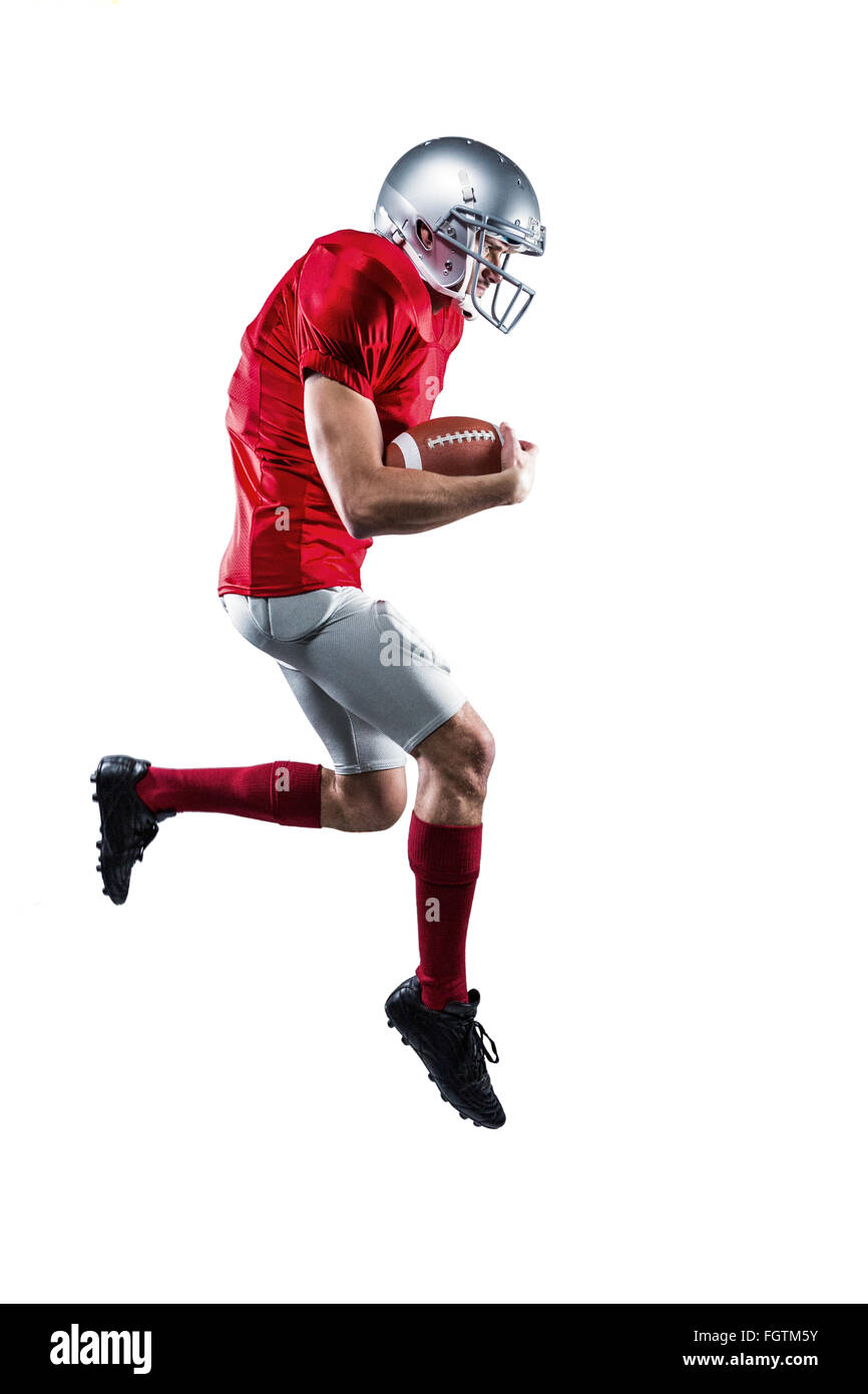 American football player holding ball while running Stock Photo - Alamy