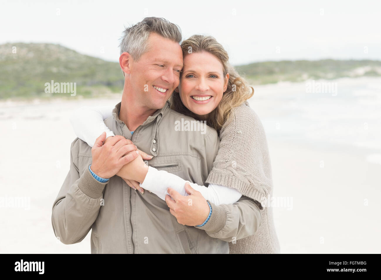 Smiling couple holding one another Stock Photo - Alamy