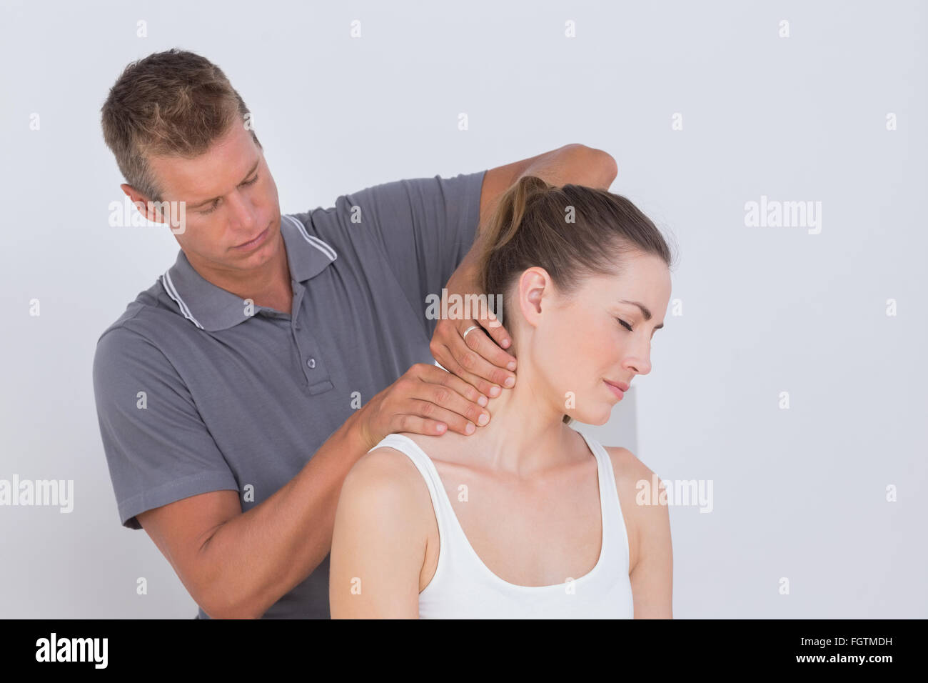 Doctor examining his patient neck Stock Photo - Alamy