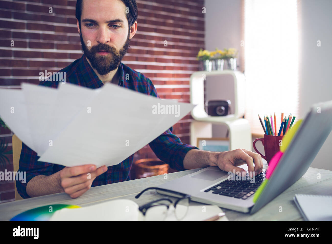 Serious creative man reading documents hi-res stock photography and ...