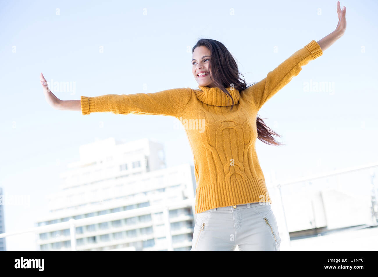 Happy woman standing with arms out Stock Photo - Alamy