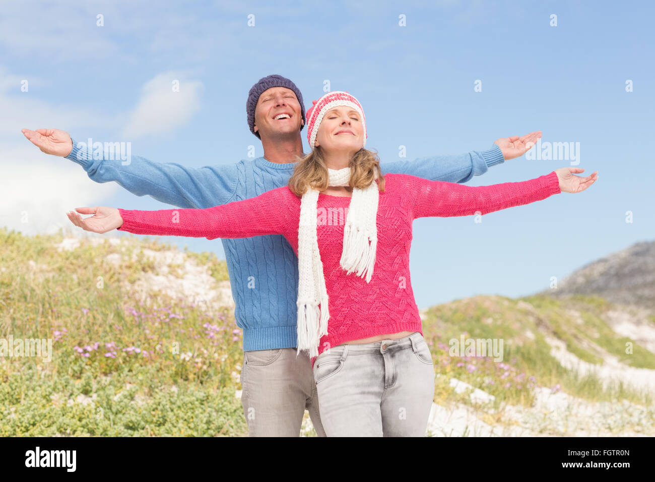 Smiling couple with arms wide open Stock Photo - Alamy