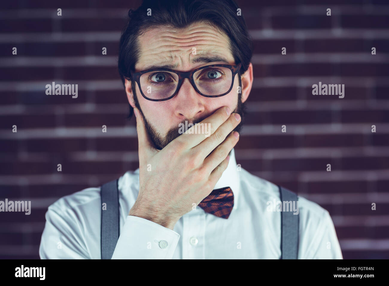 Portrait of nervous man covering mouth Stock Photo - Alamy