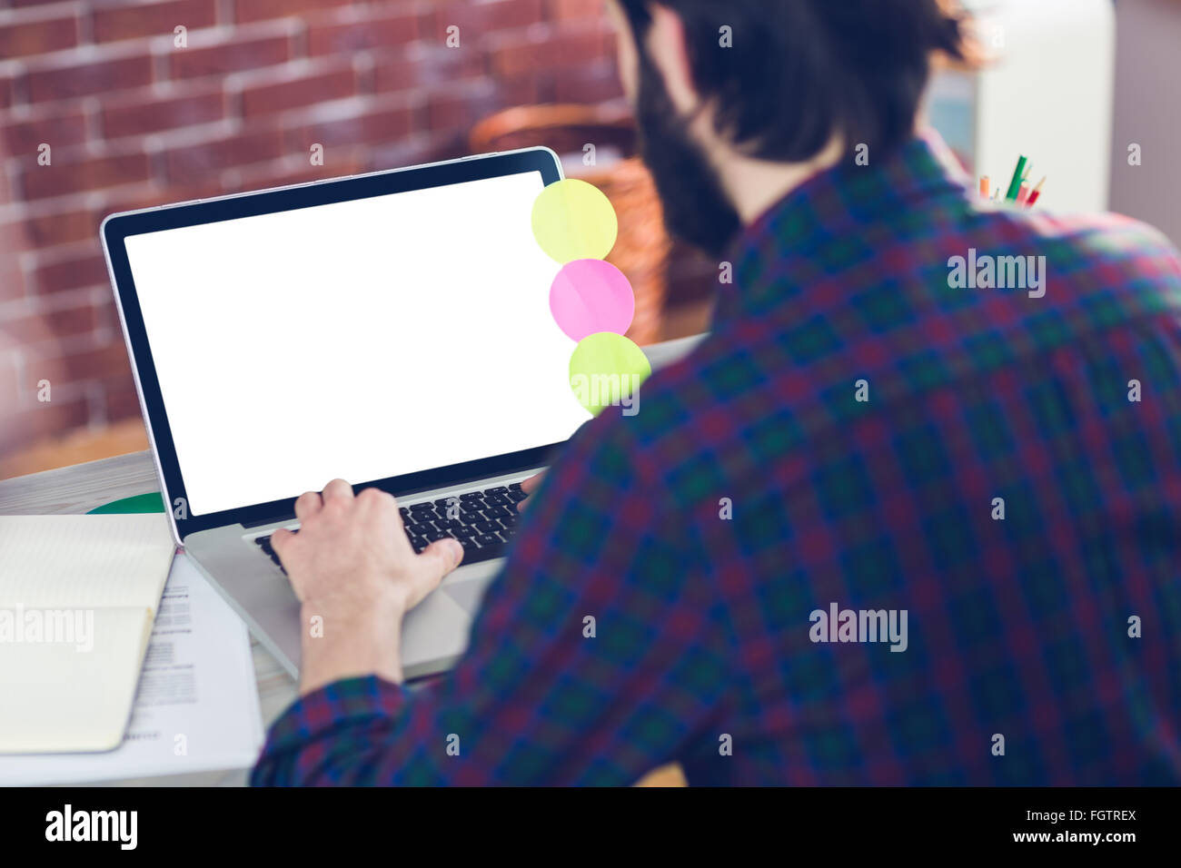 Rear view of creative editor working on laptop Stock Photo - Alamy