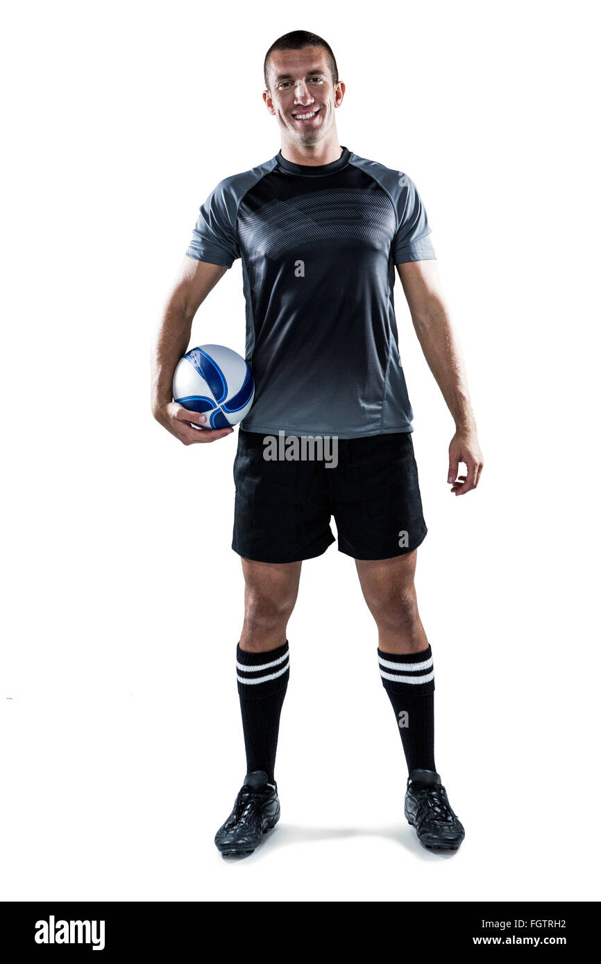 Full length portrait of smiling rugby player in black jersey holding ...