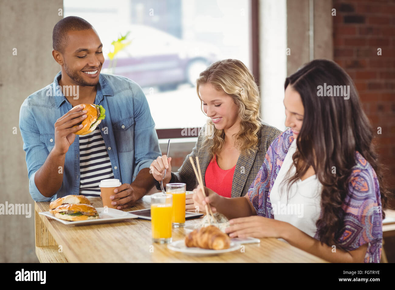 Business people having breakfast in office Stock Photo - Alamy
