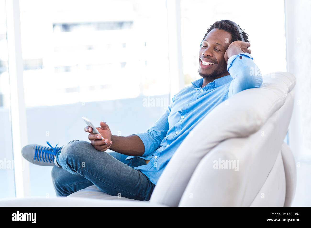 Relaxed man enjoying music Stock Photo - Alamy