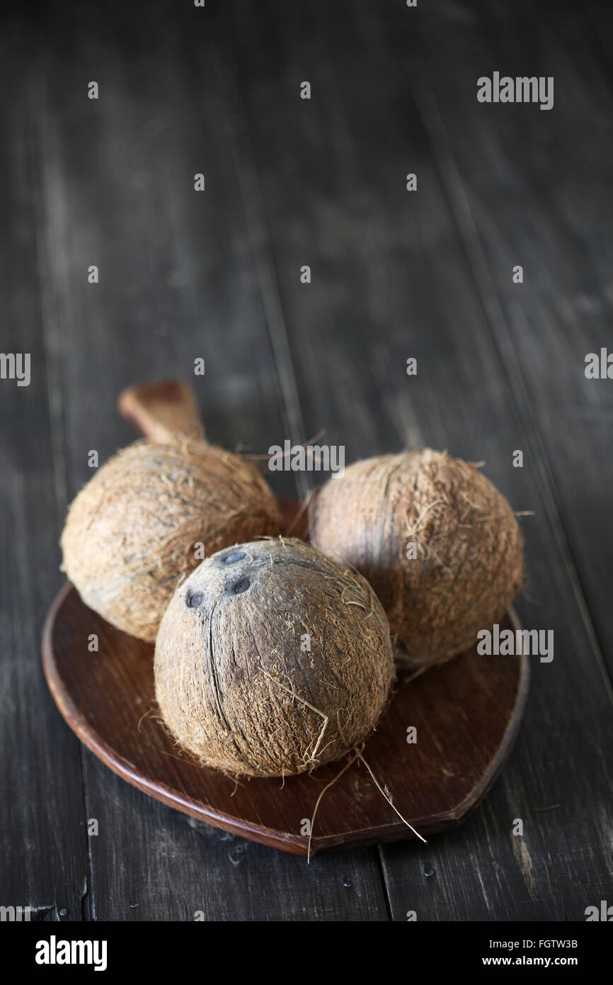 three whole coconuts Stock Photo - Alamy