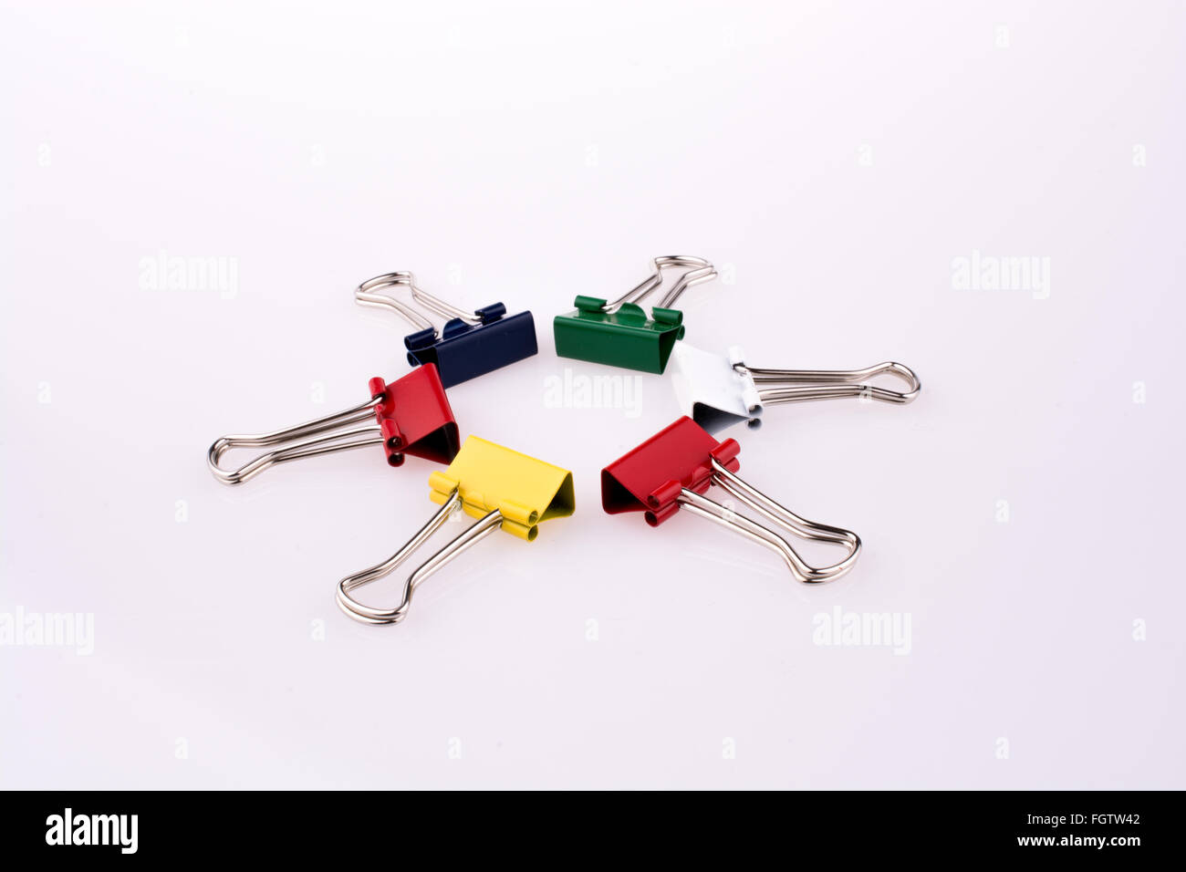 Colored paper clips on a white background Stock Photo - Alamy