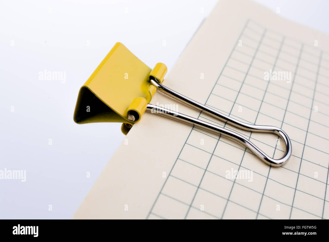 Colored paper clip on a checked notebook page Stock Photo - Alamy