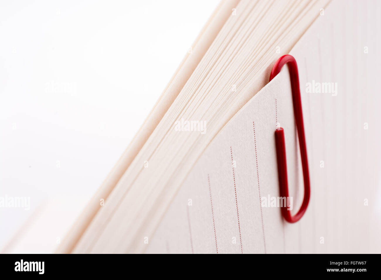 Colored paper clip on a checked notebook page Stock Photo - Alamy