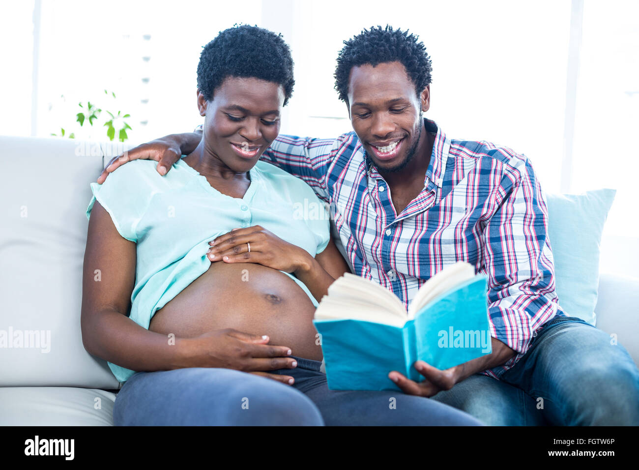 Pregnant woman smiling with partner Stock Photo - Alamy