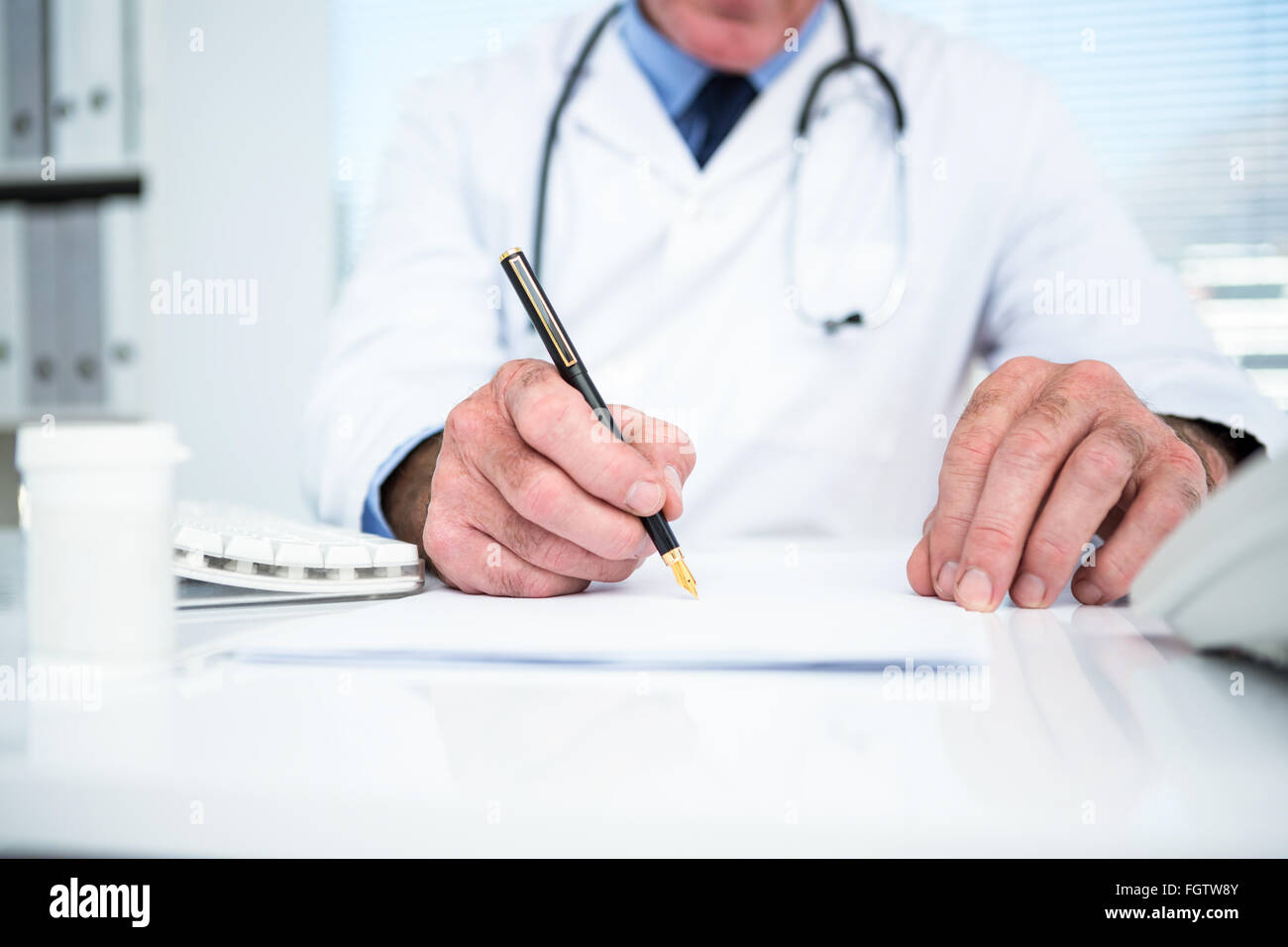 Physician writing in notepad hi-res stock photography and images - Alamy