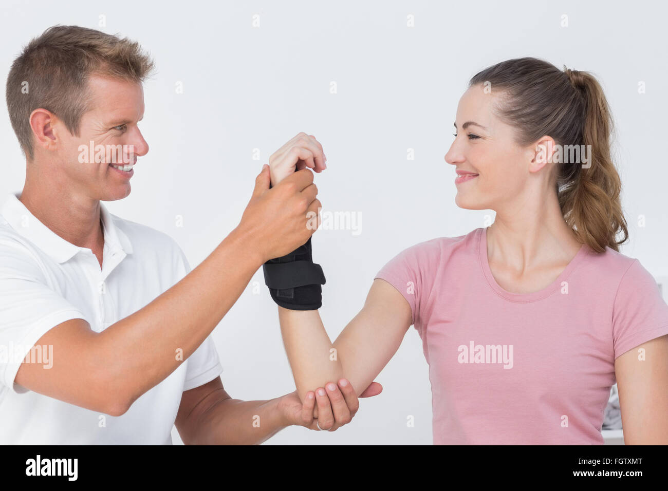 Doctor examining a woman wrist Stock Photo - Alamy