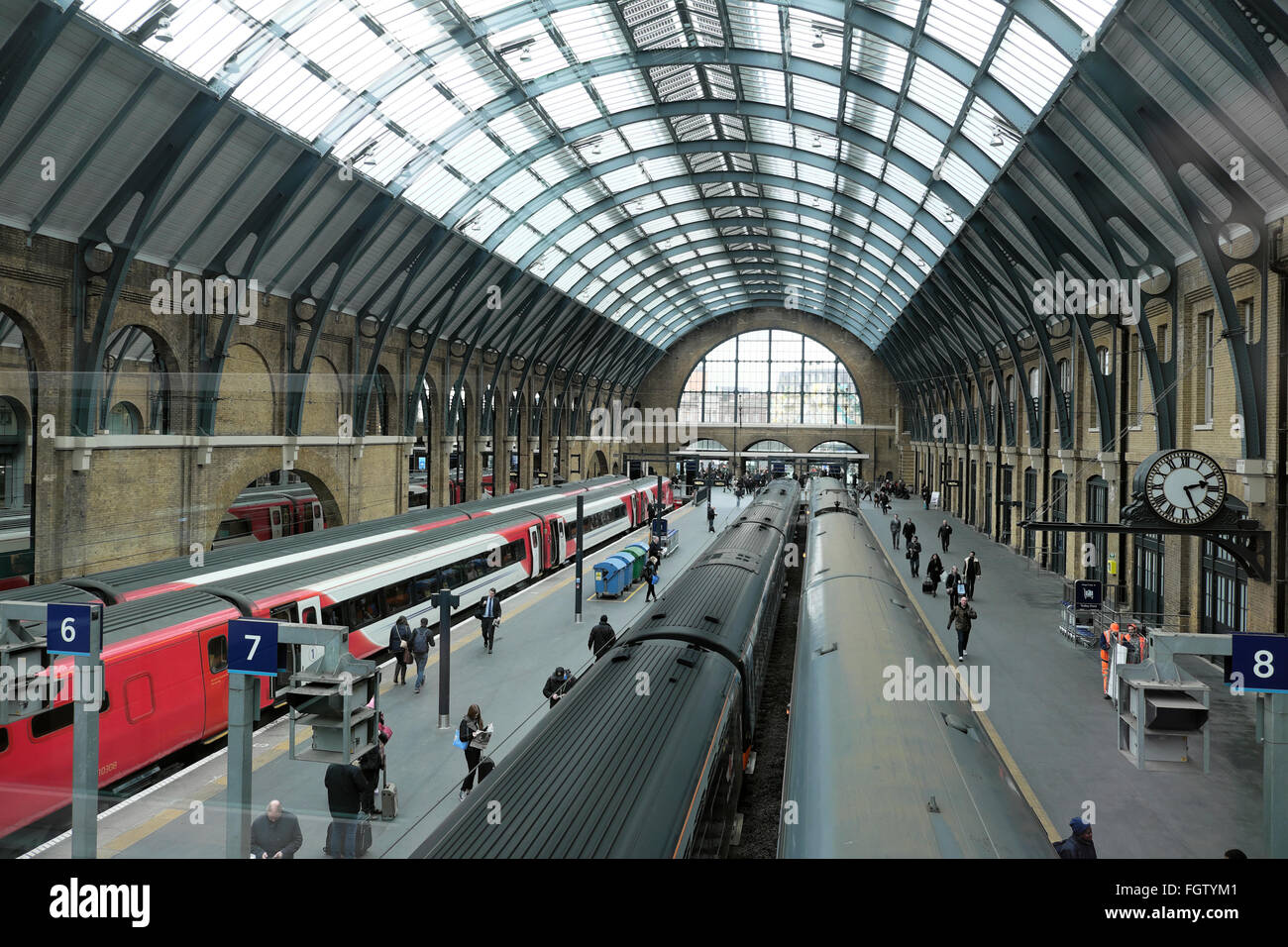 Passengers on the platform boarding trains at Kings Cross Station in ...