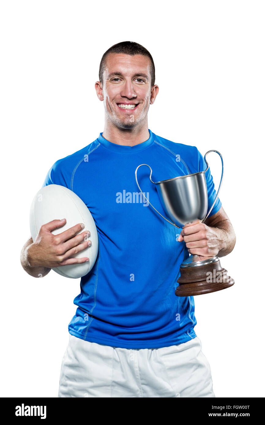 Portrait of smiling rugby player holding trophy and ball Stock Photo ...